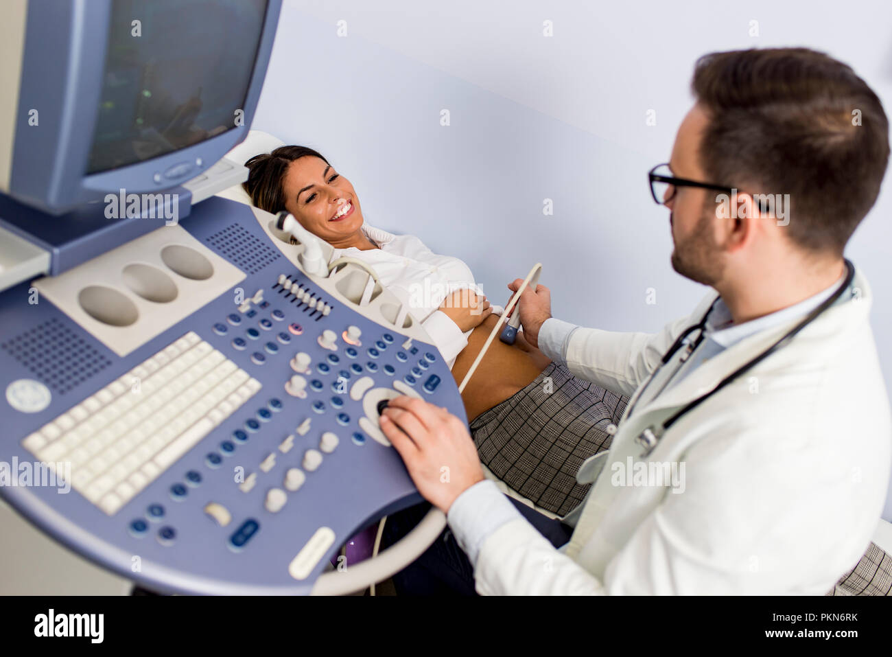 Doctor doing medical examination of patient with ultra sound scanner ...