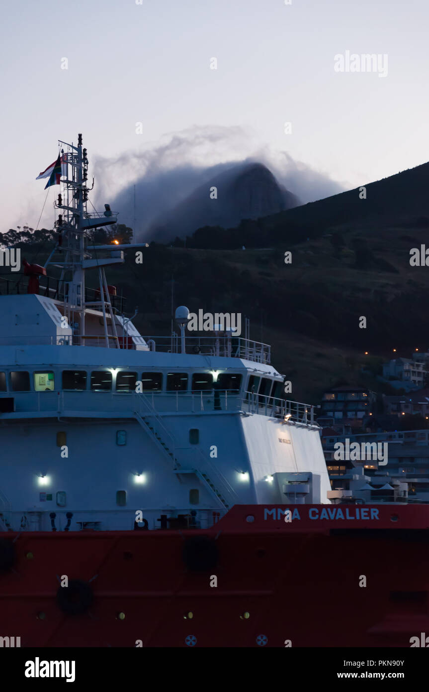 The MMA Cavalier, an offshore supply ship at night with Signal Hill ...