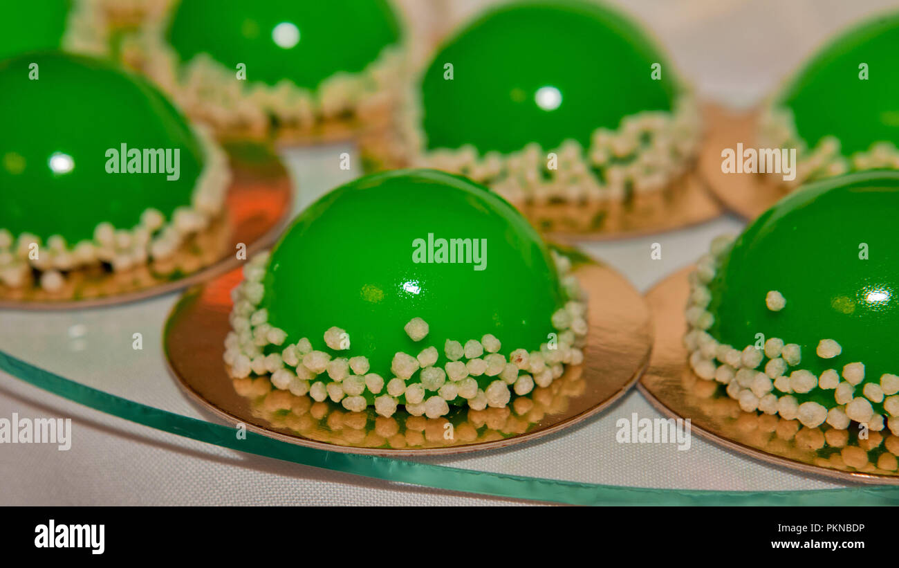 Trendy musk cake decorated with green mirror glaze. Concept of St ...