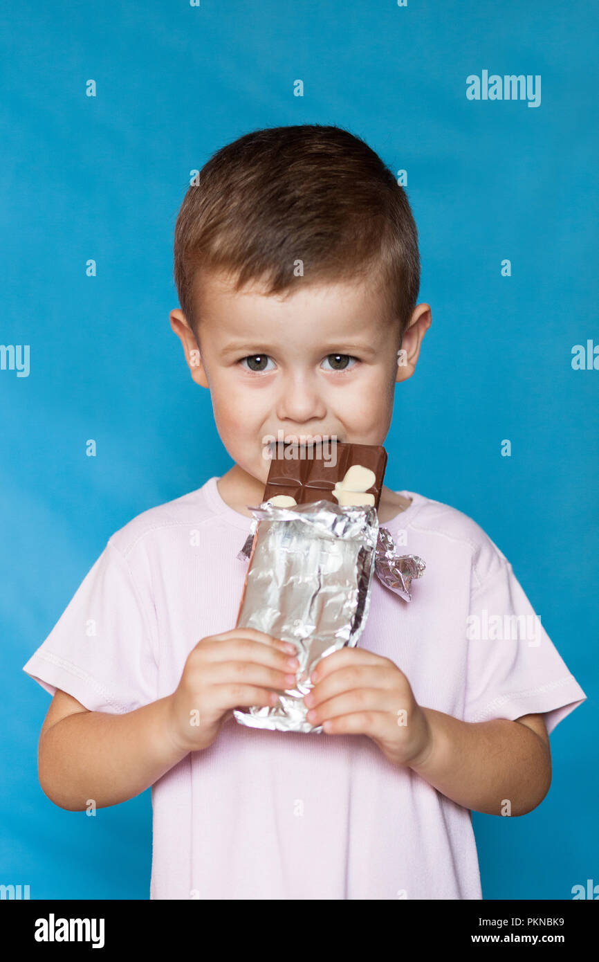 Cute Little Boy Eating Chocolate Bar. Very cute kid with chocolate ...