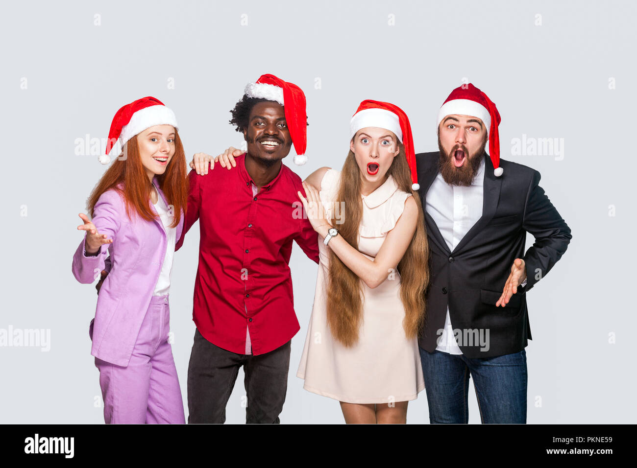 Group of beautiful happy handsome friends in red cap standing and ...