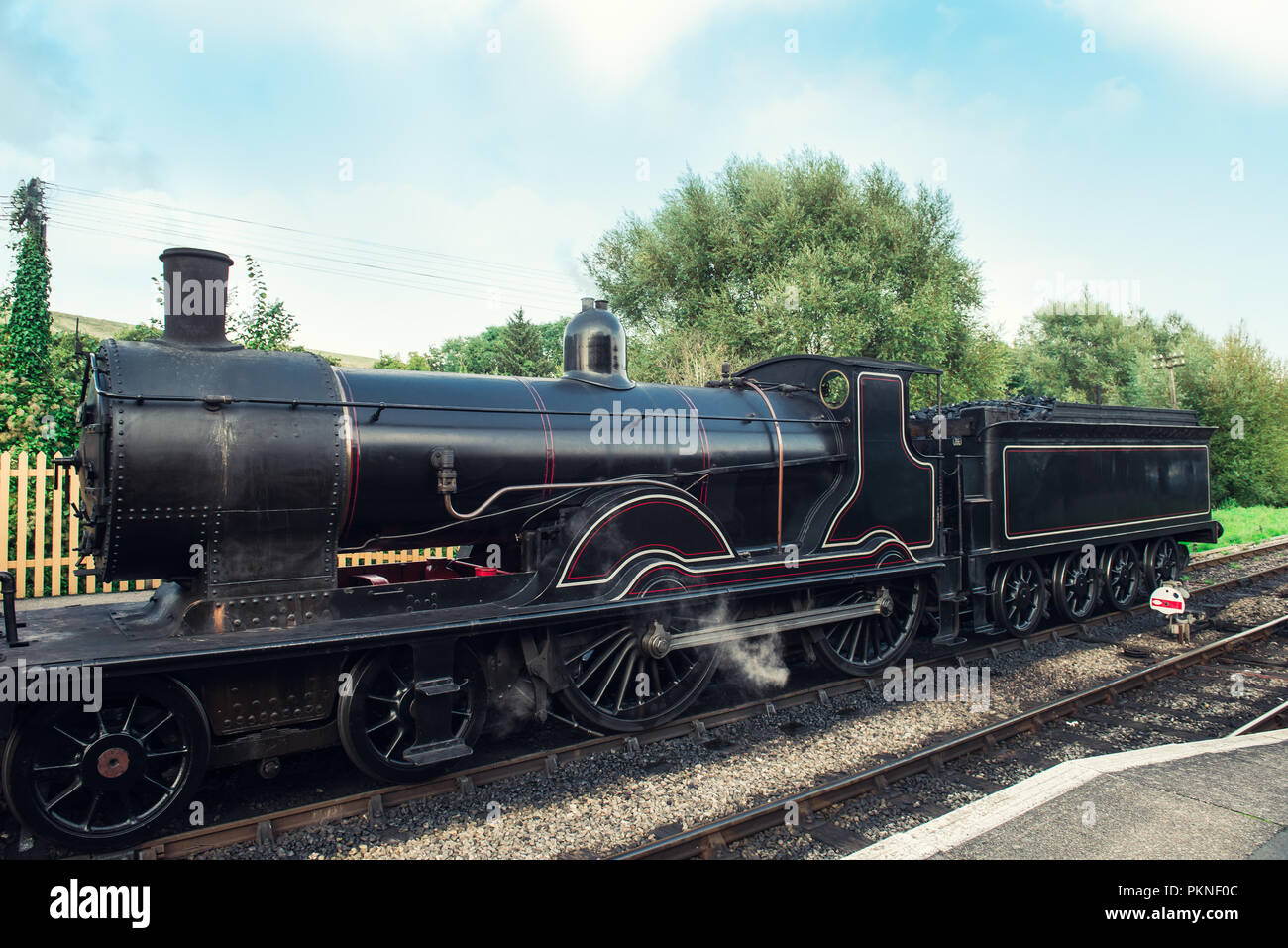 Old Steam locomotive on railroad station. Vintage Steam railway road ...