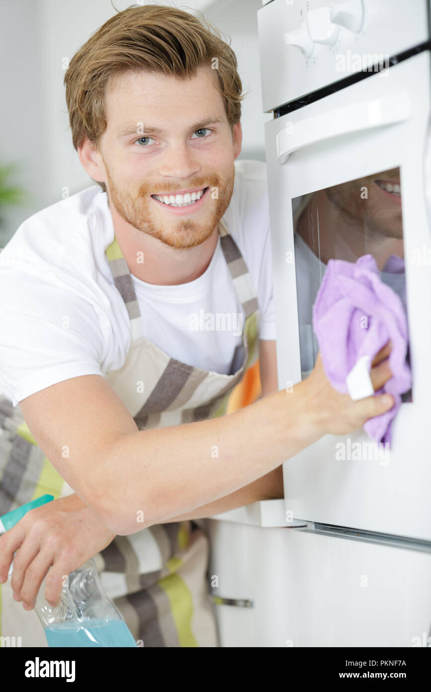Handsome smiling cleaner washing hi-res stock photography and images ...