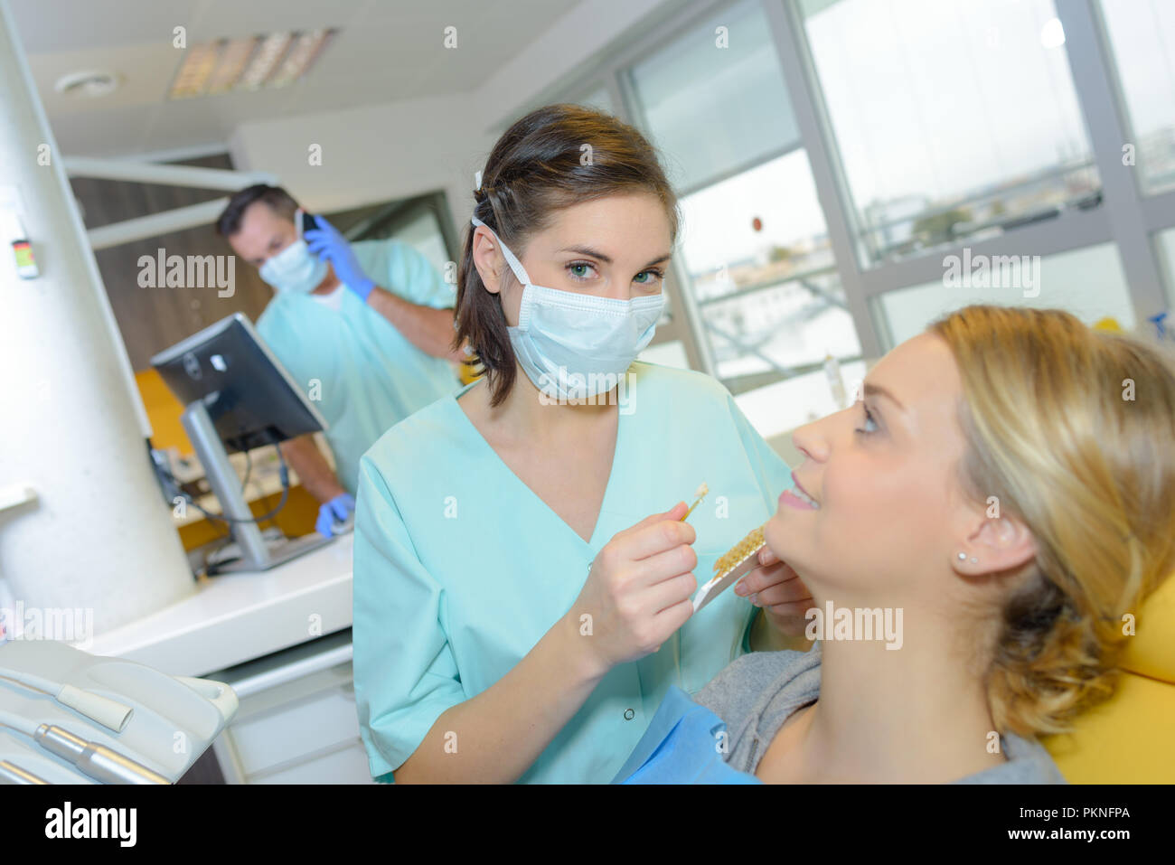 dentist curing a woman patient in the dental office Stock Photo - Alamy