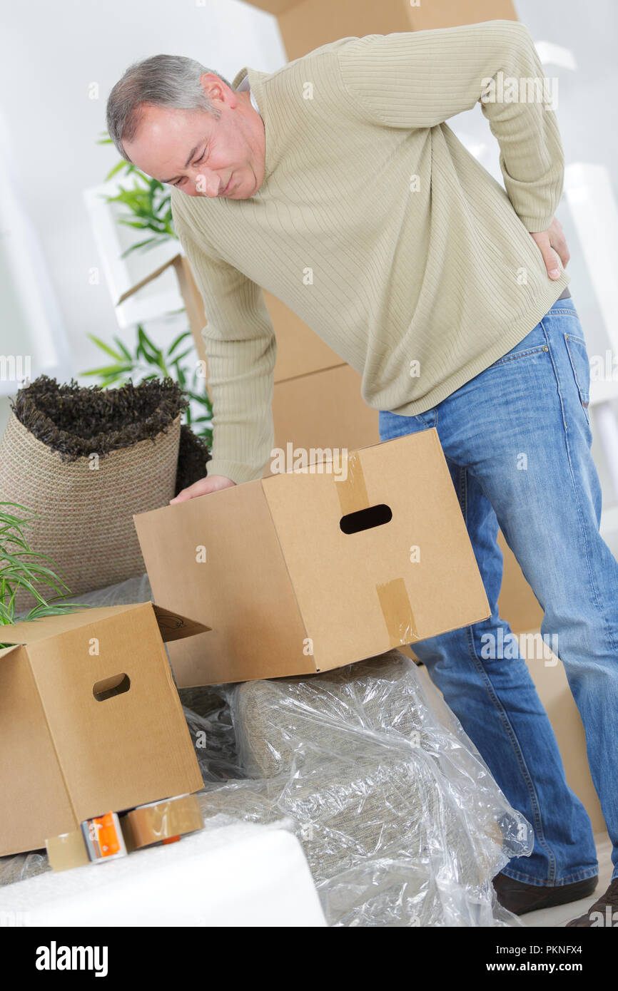 man is moving having pain in his back while packing Stock Photo - Alamy
