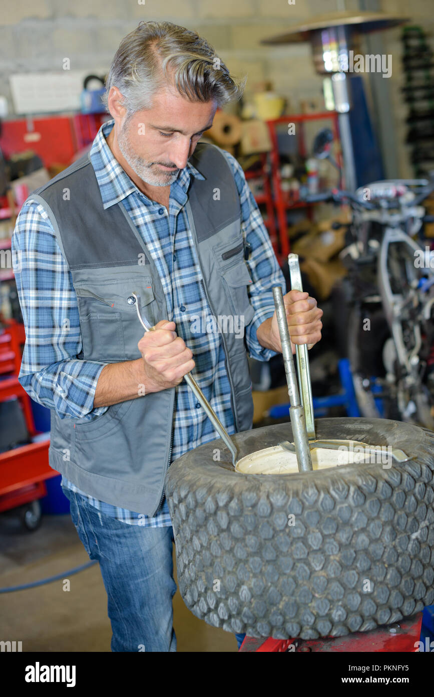 tire changer doing his work Stock Photo - Alamy