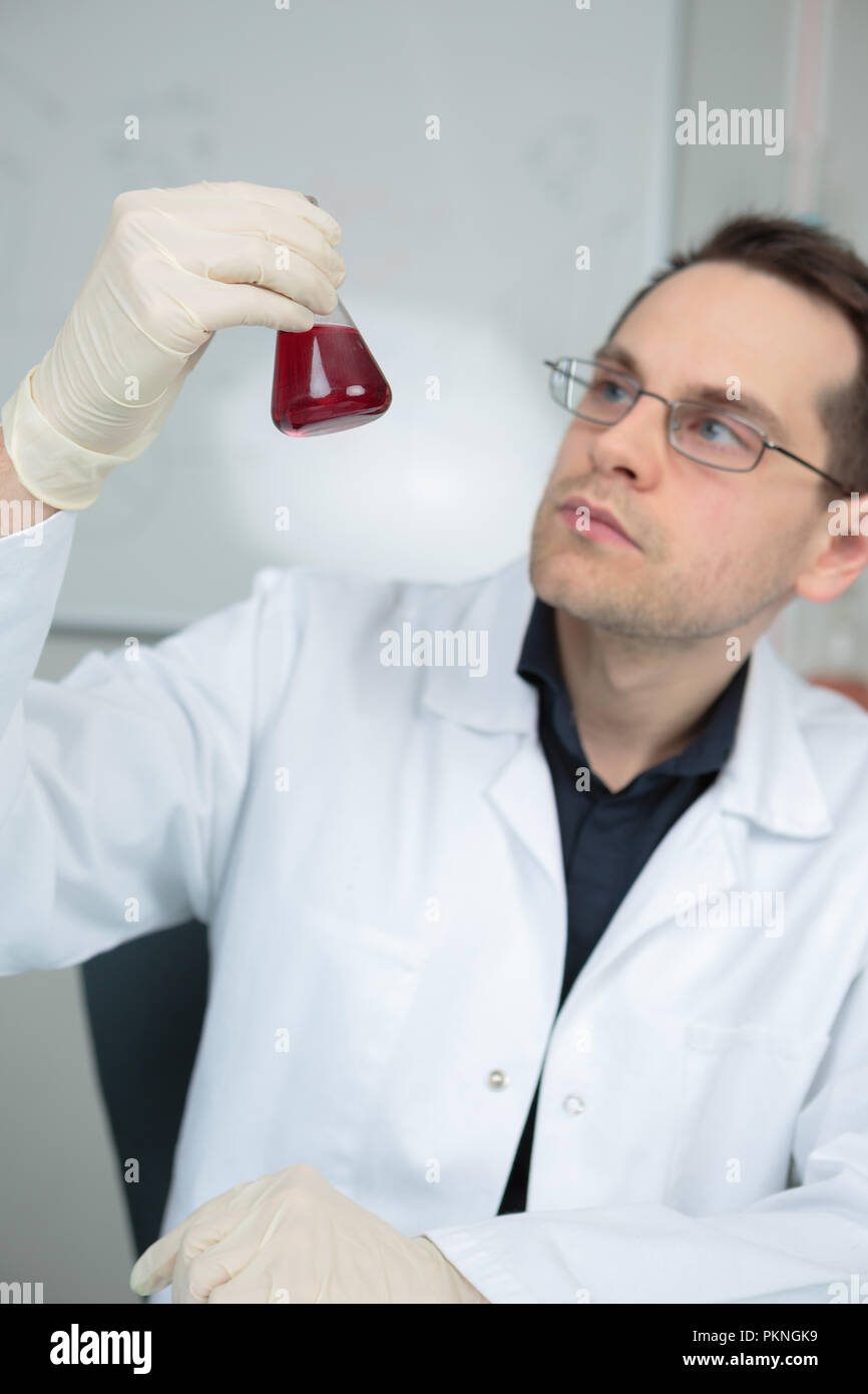 Holding flask fluid hi-res stock photography and images - Alamy