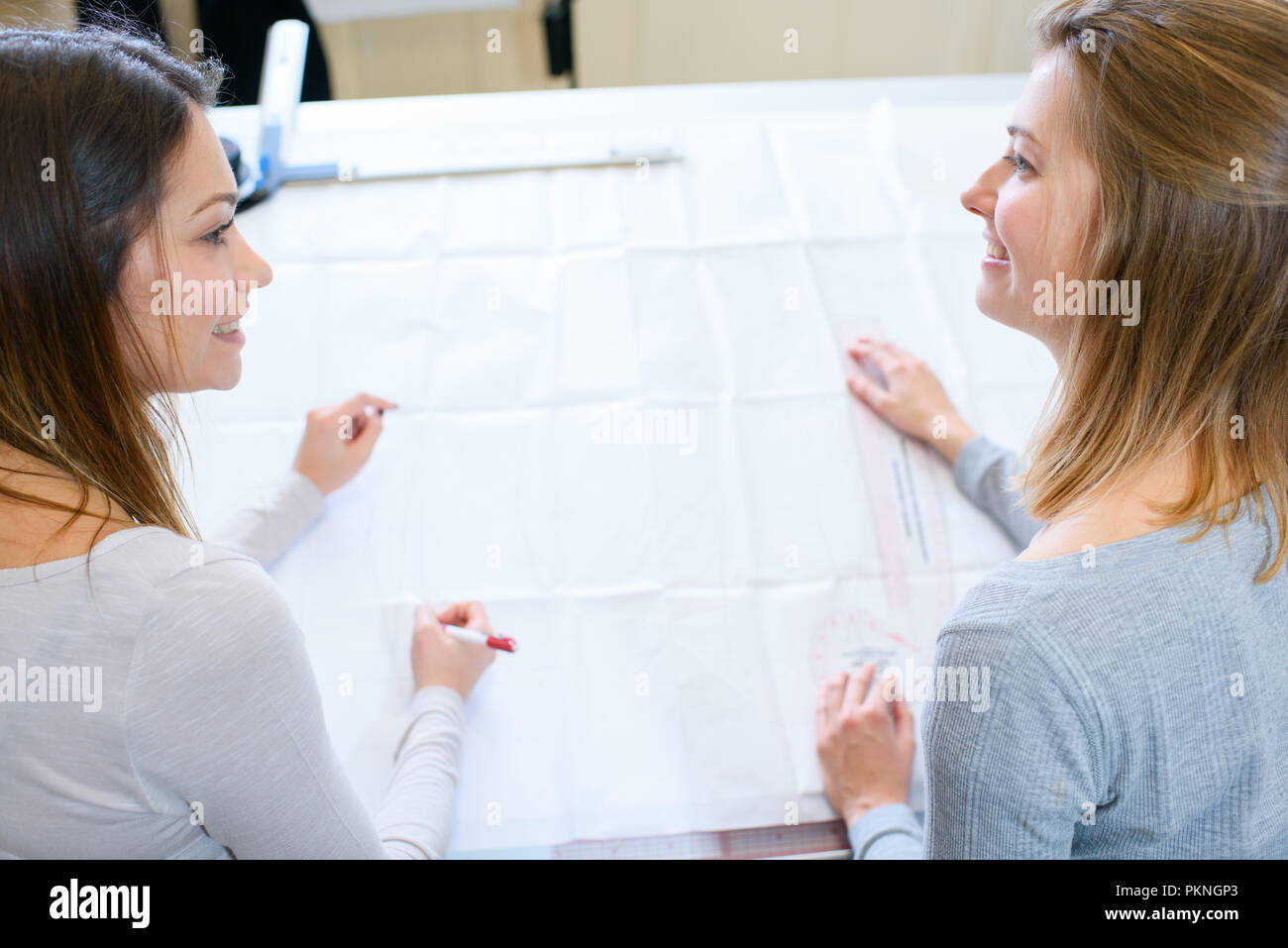 two young girls students drawing together Stock Photo - Alamy