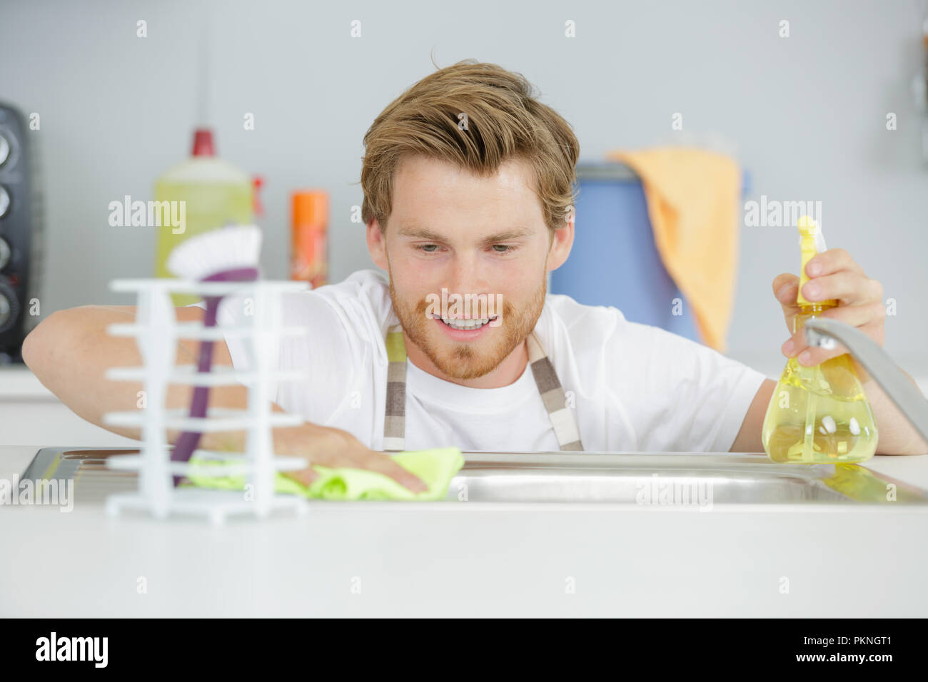 smiling young man cleaning Stock Photo - Alamy