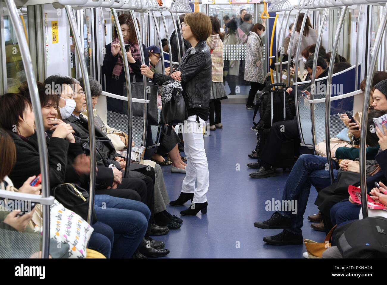 TOKYO, JAPAN - DECEMBER 4, 2016: Passengers ride a metro train in Tokyo ...