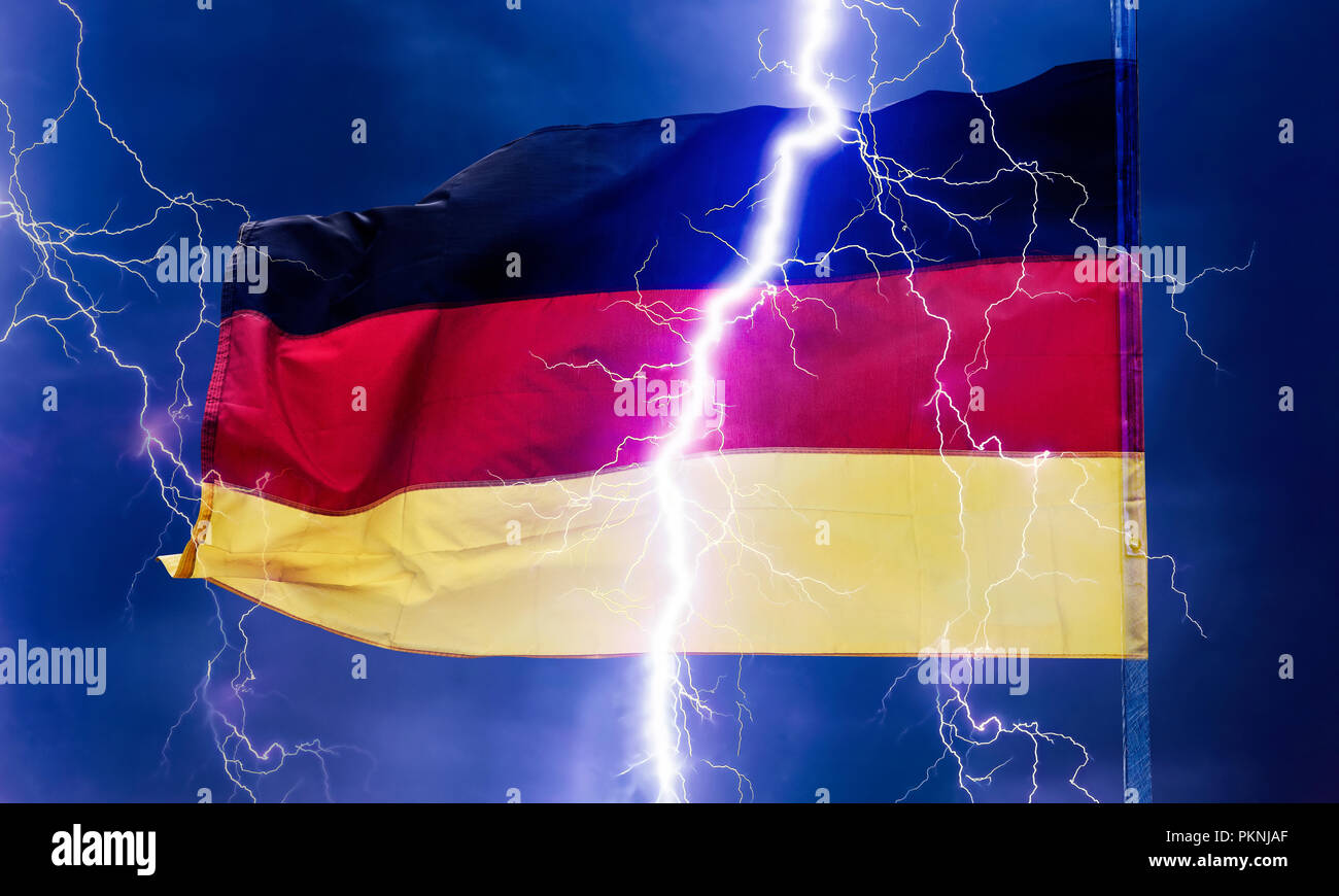A flash of lightning seems to split an German flag into two parts Stock ...