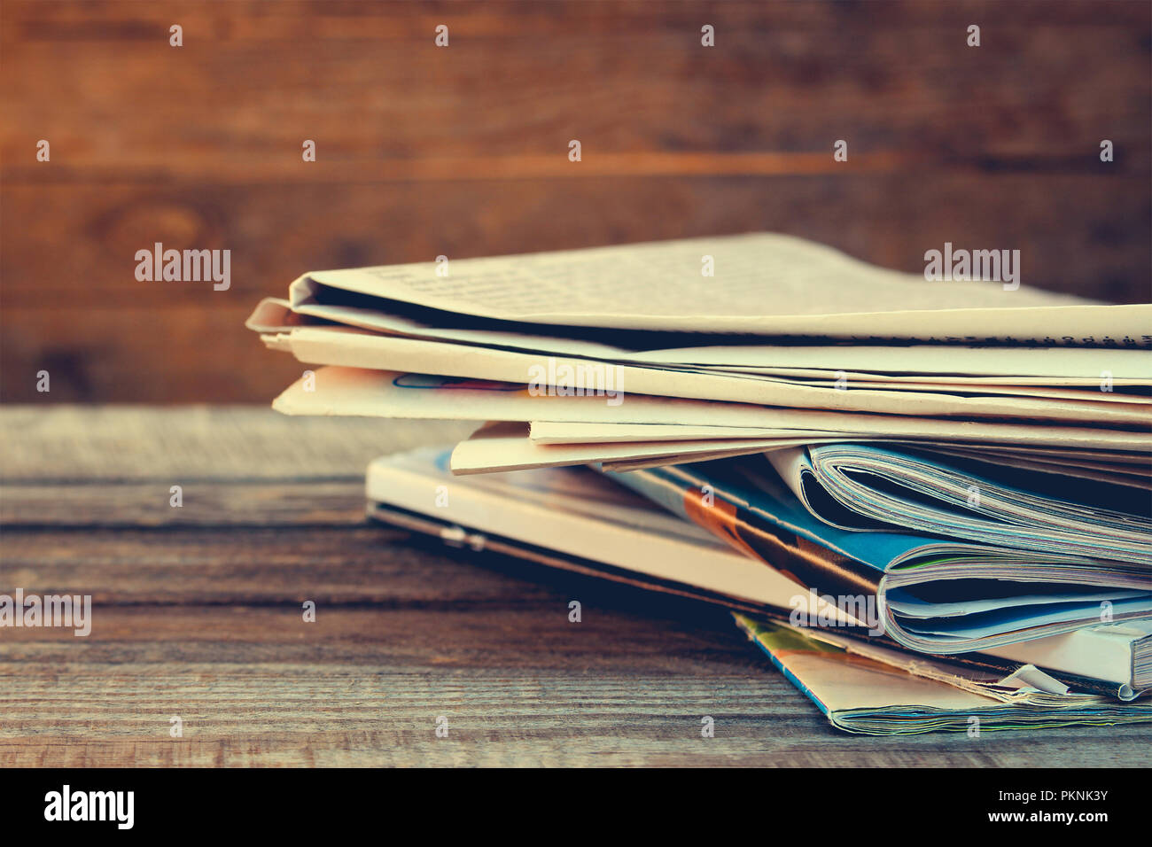 Newspapers and magazines on old wood background. Toned image Stock ...