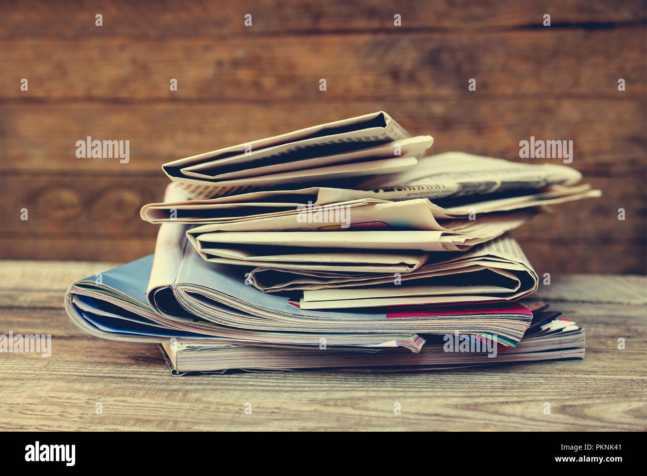 Newspapers and magazines on old wood background. Toned image Stock ...