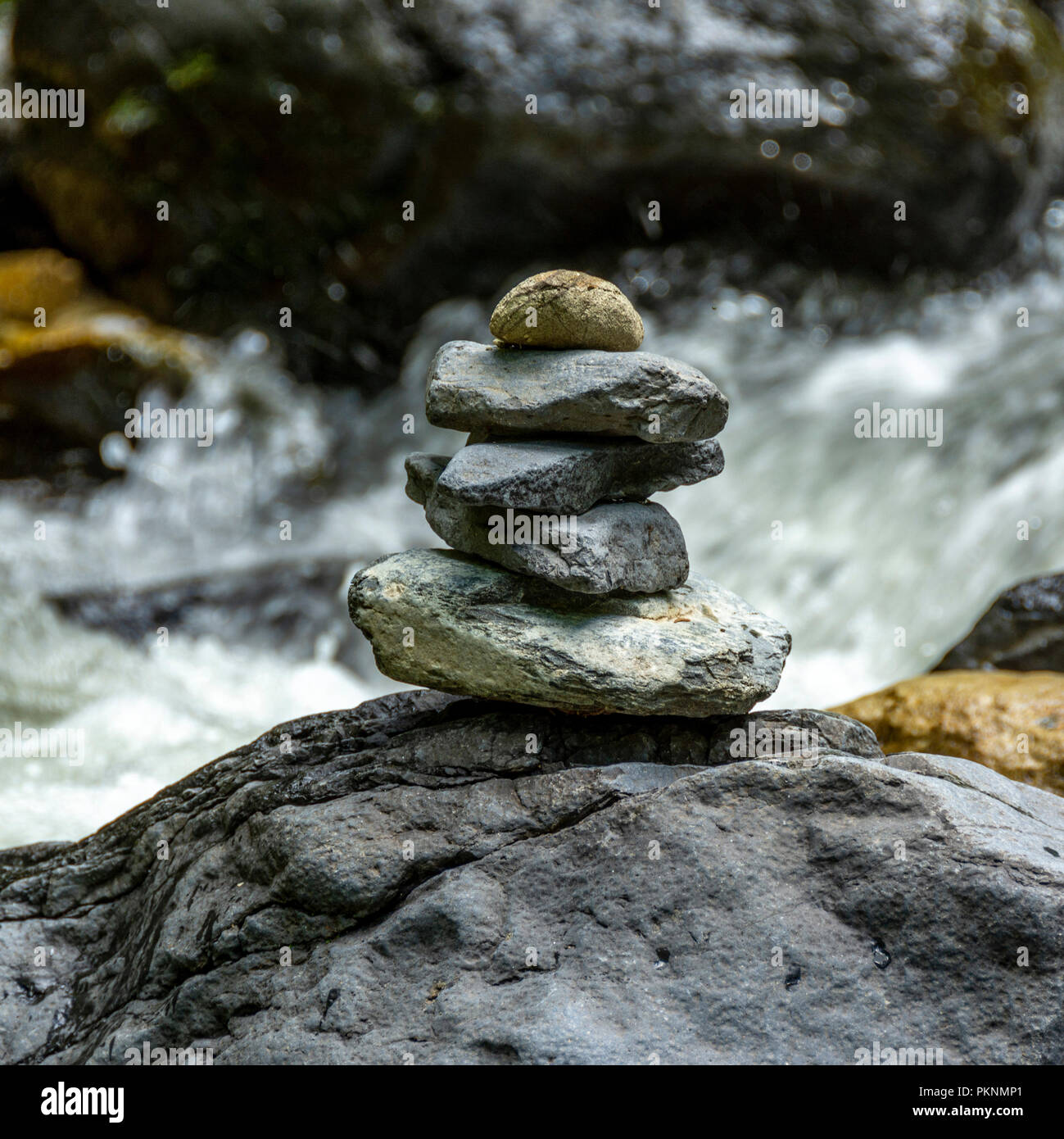 Stack of rocks by a river, Auvergne Volcanoes Natural Regional Park ...
