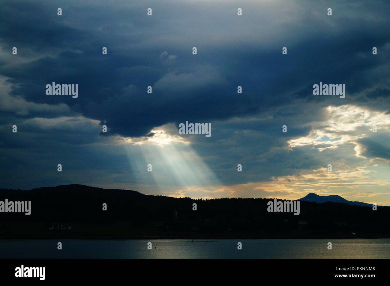 Sunbeam breaking through clouds Stock Photo - Alamy