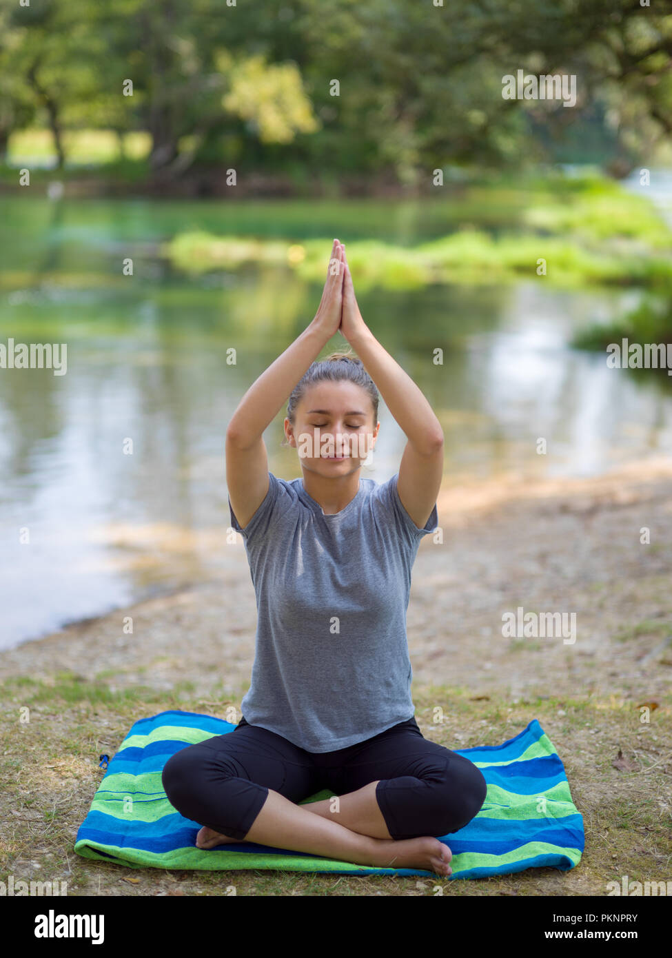 healthy woman relaxing while meditating and doing yoga exercise in the ...