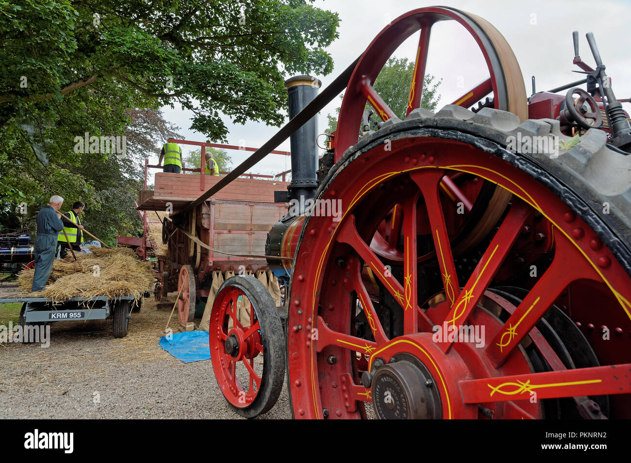 A threshing machine being powered by a traction engine at the 2018 Low ...