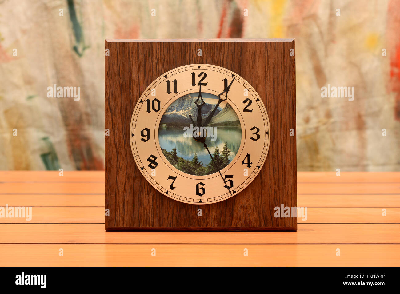 Wooden wall clock on table, time concept Stock Photo - Alamy
