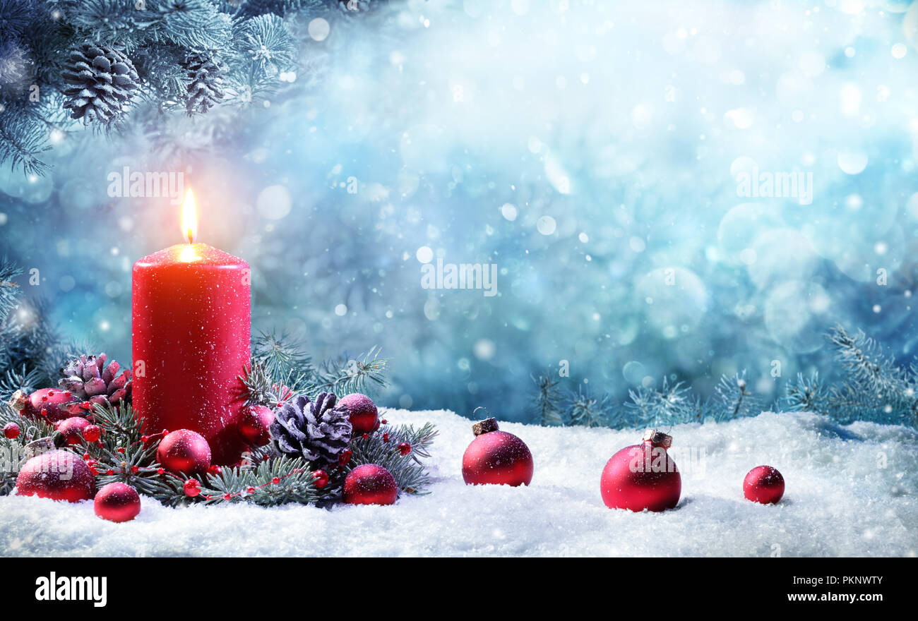 Advent Candle With Fir Branches Burning In Snowy Scene Stock Photo - Alamy
