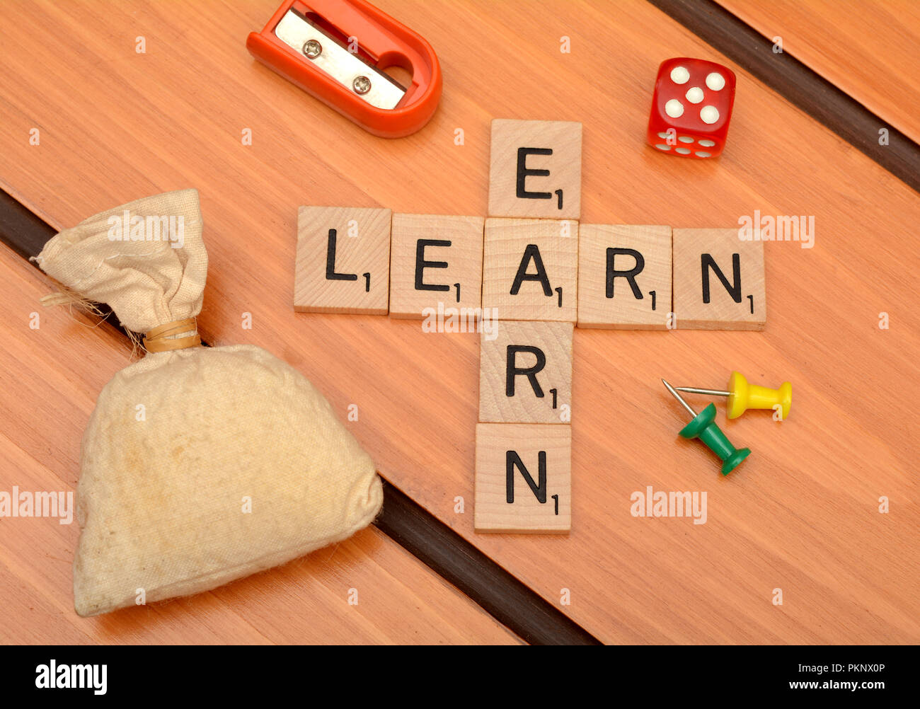 Learn & Earn theme on wooden background with stationery items Stock ...