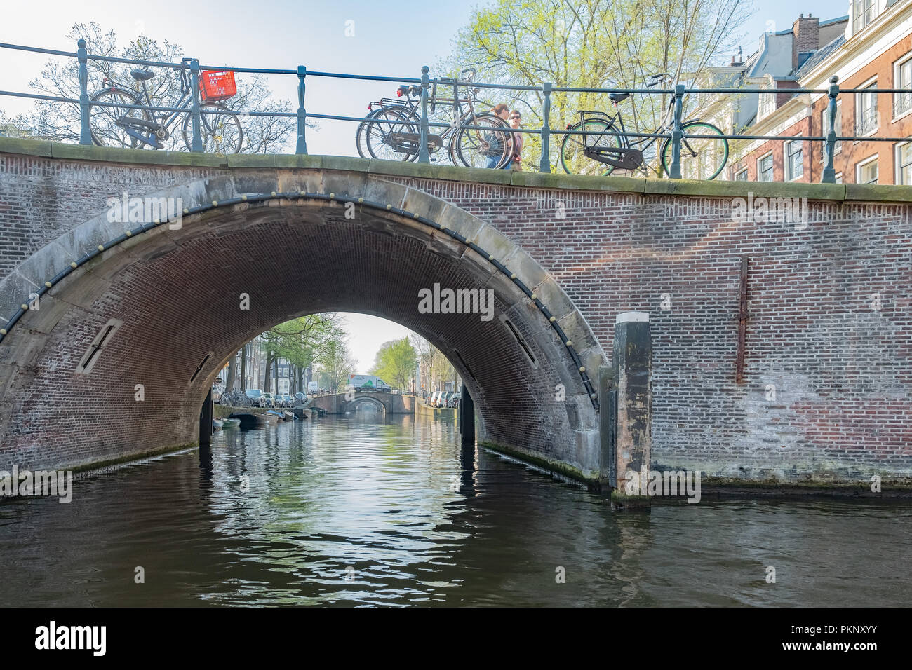 Classic brick bridge scene with bicycles over one of the historic ...