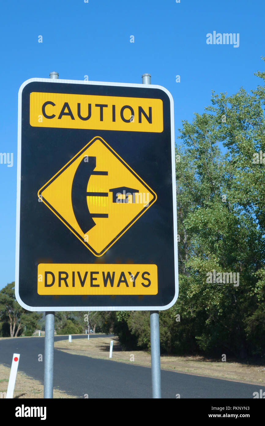 Caution Driveways signage beside a road, Australia Stock Photo - Alamy
