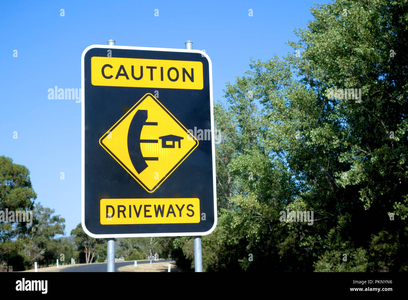 Caution Driveways signage beside a road, Australia Stock Photo - Alamy