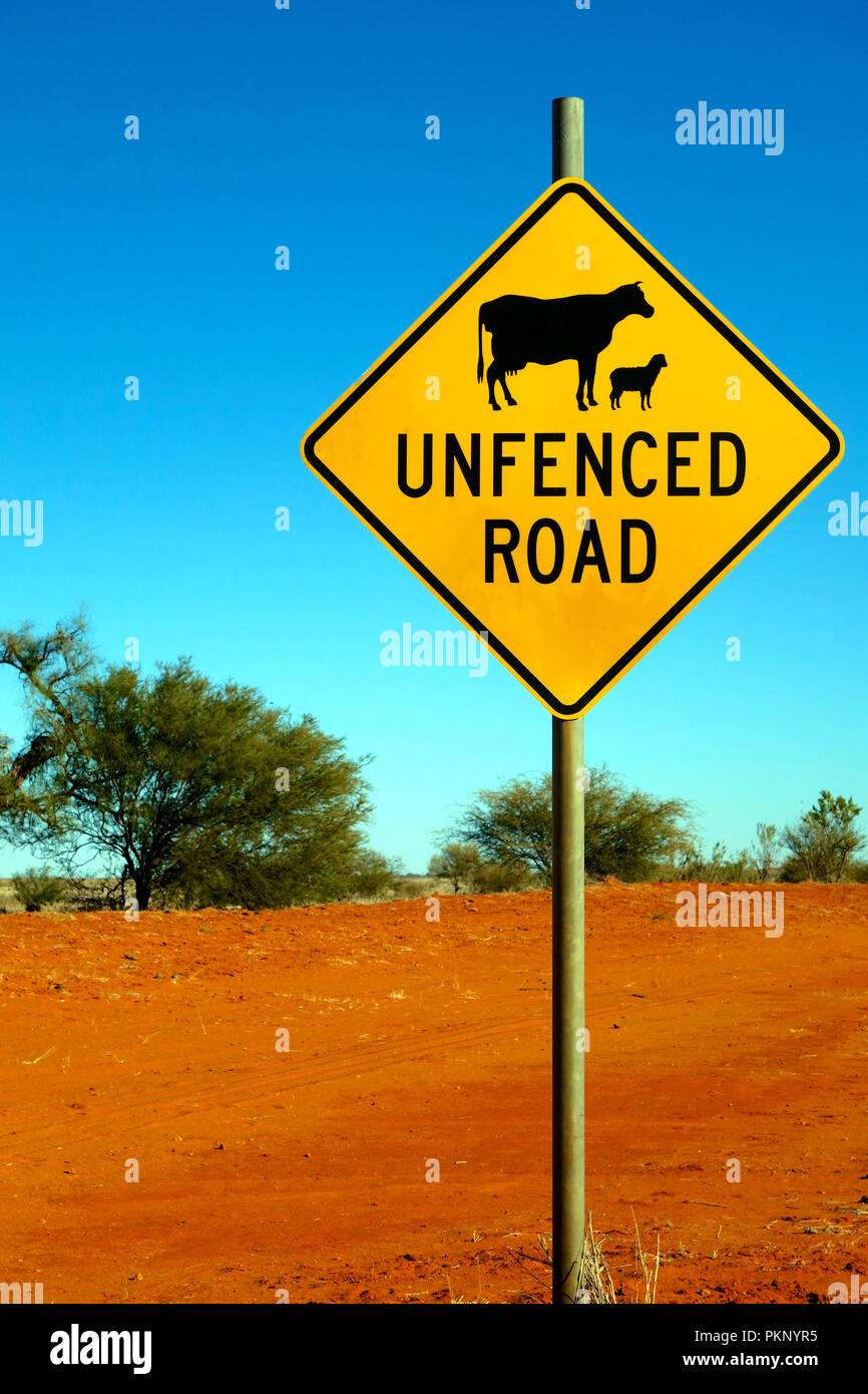 Unfenced Road sign warning of straying cattle and sheep in outback ...