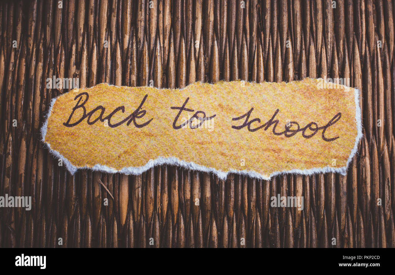 Back to school wording on a piece of torn paper Stock Photo - Alamy