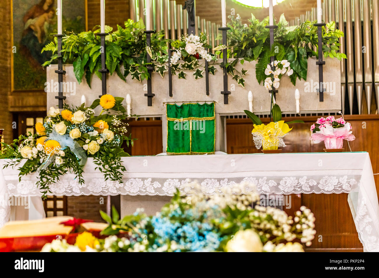 flowers on altar in Catholic church in Italy Stock Photo - Alamy