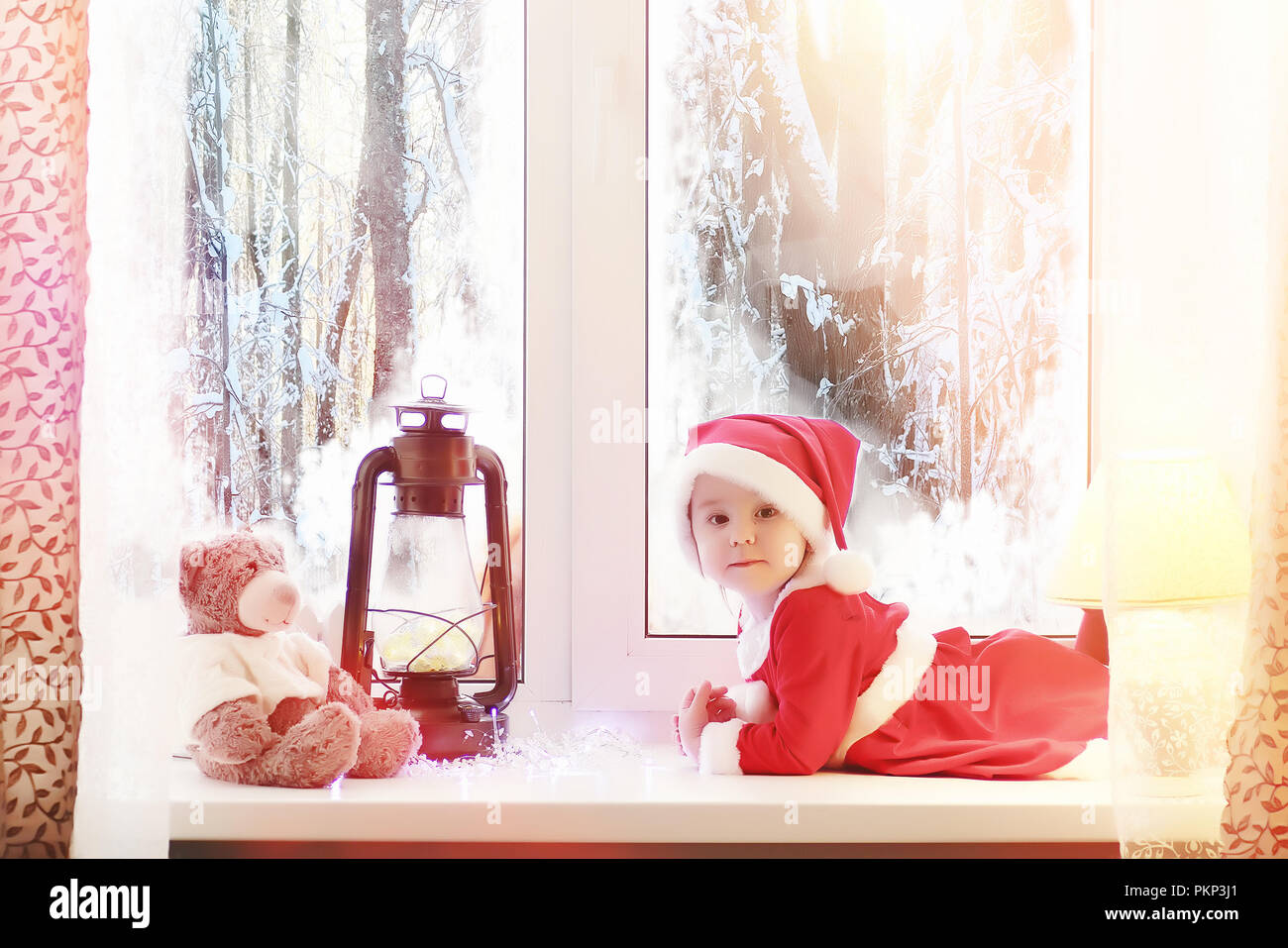 A child in the new year looks out the window. Children are waiti Stock ...