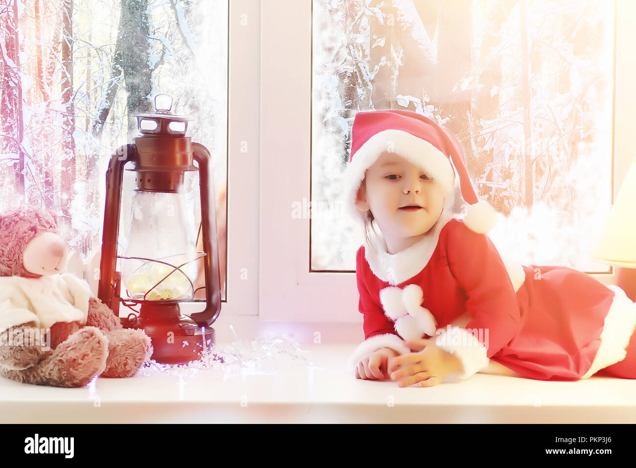 A child in the new year looks out the window. Children are waiti Stock ...