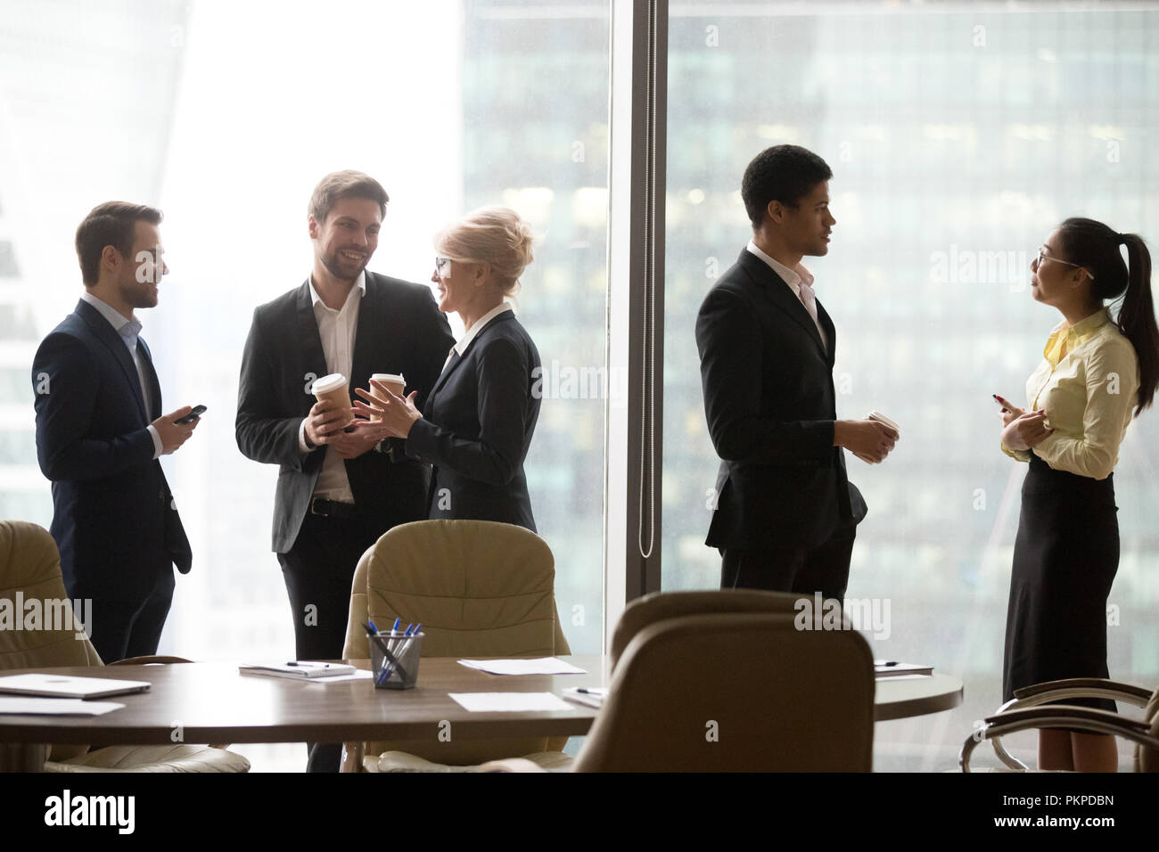 Multiracial, business people talking in break and drink coffee Stock ...