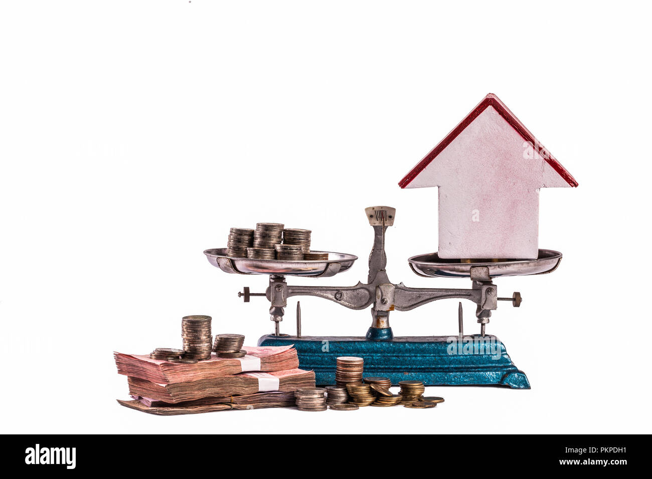 Different kinds money on scale in white background with clipping path ...