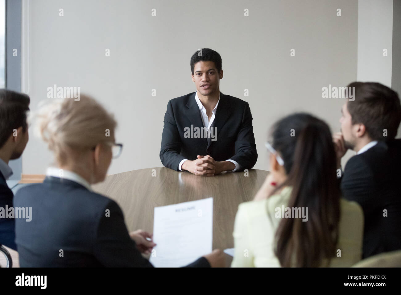 Group of employees interviewing new african worker at office boa Stock ...