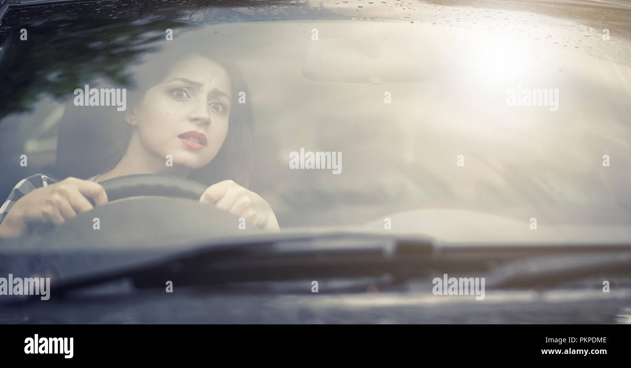 Girl driving a car bad emotions Stock Photo - Alamy