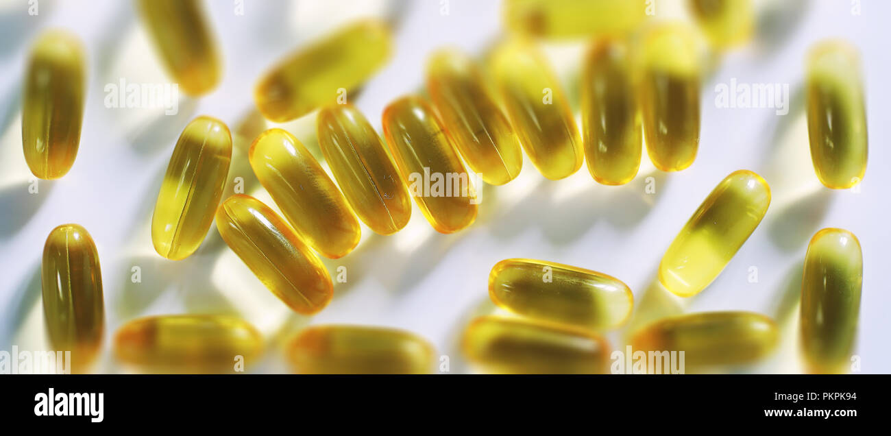 Medical drugs transparent capsules of yellow color Stock Photo - Alamy
