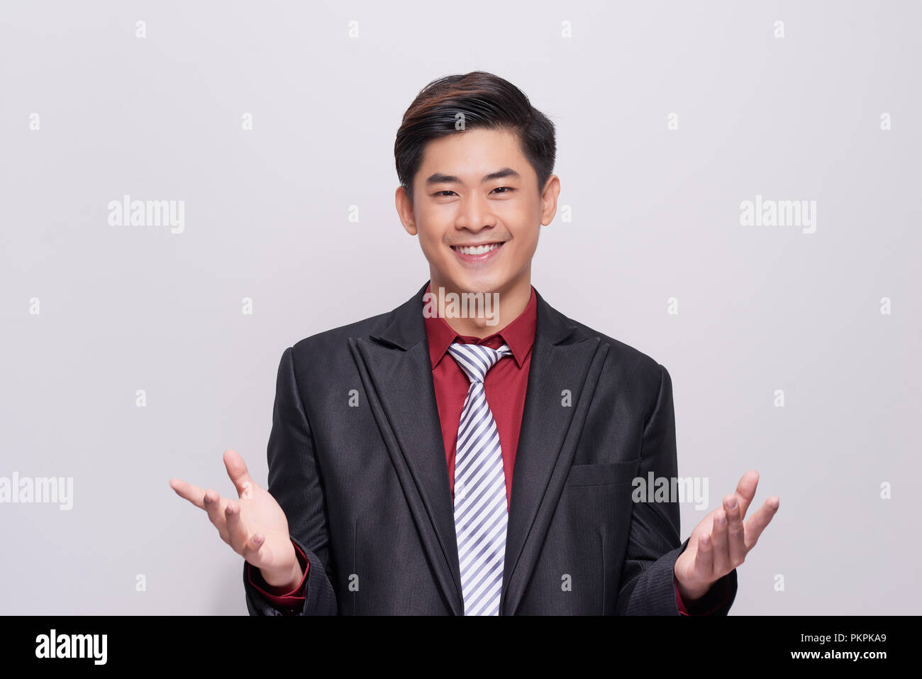 Handsome and well dressed businessman in a suit, tie and vest, standing ...