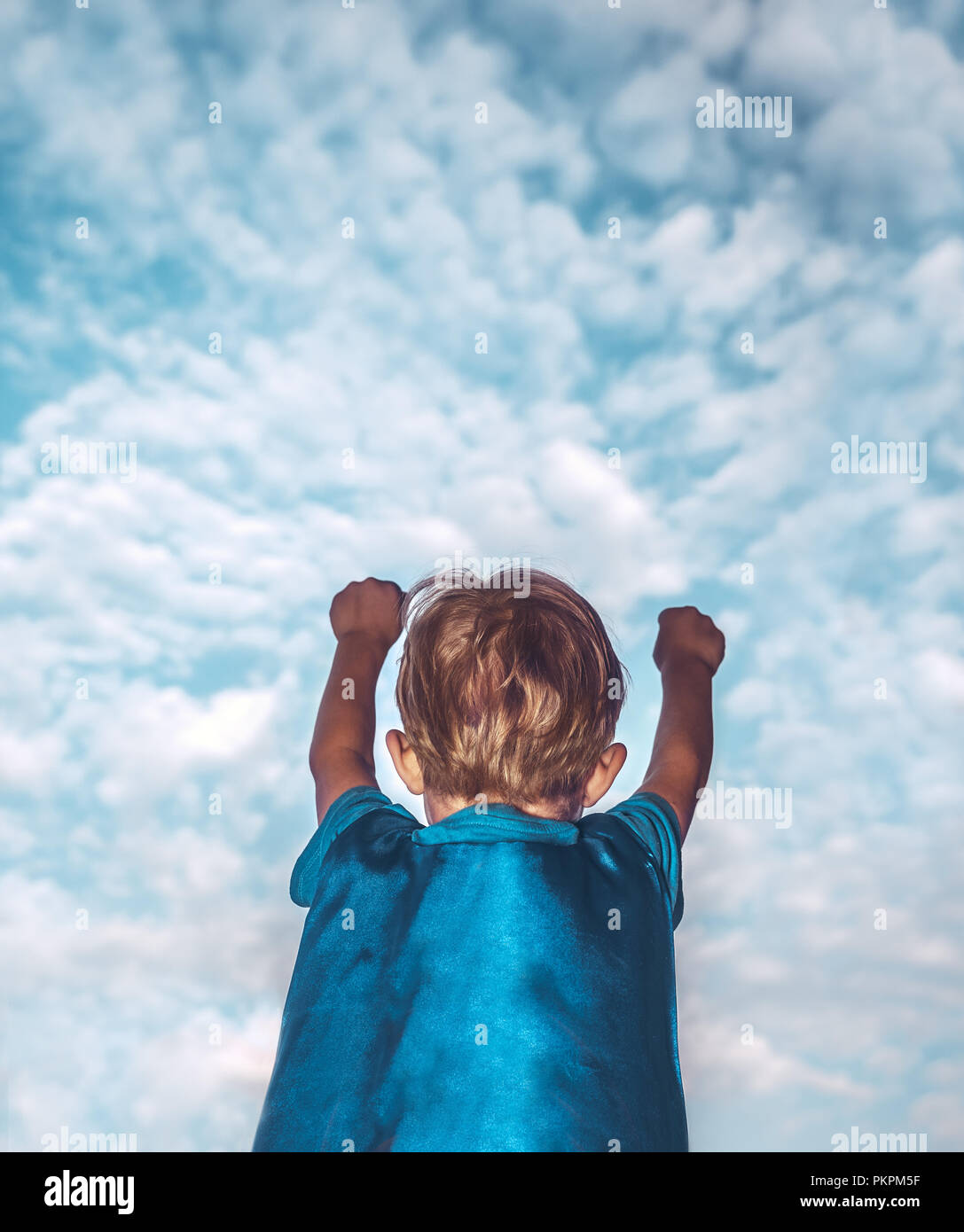 The boy plays in superman, rear view of a little boy wearing superhero ...