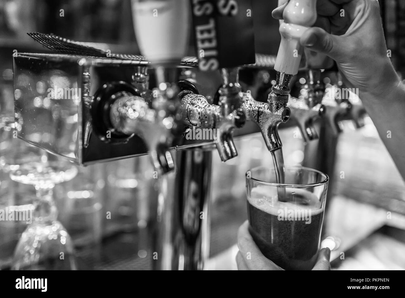 Black and white shot of a bartender pouring a pint of draft beer Stock ...