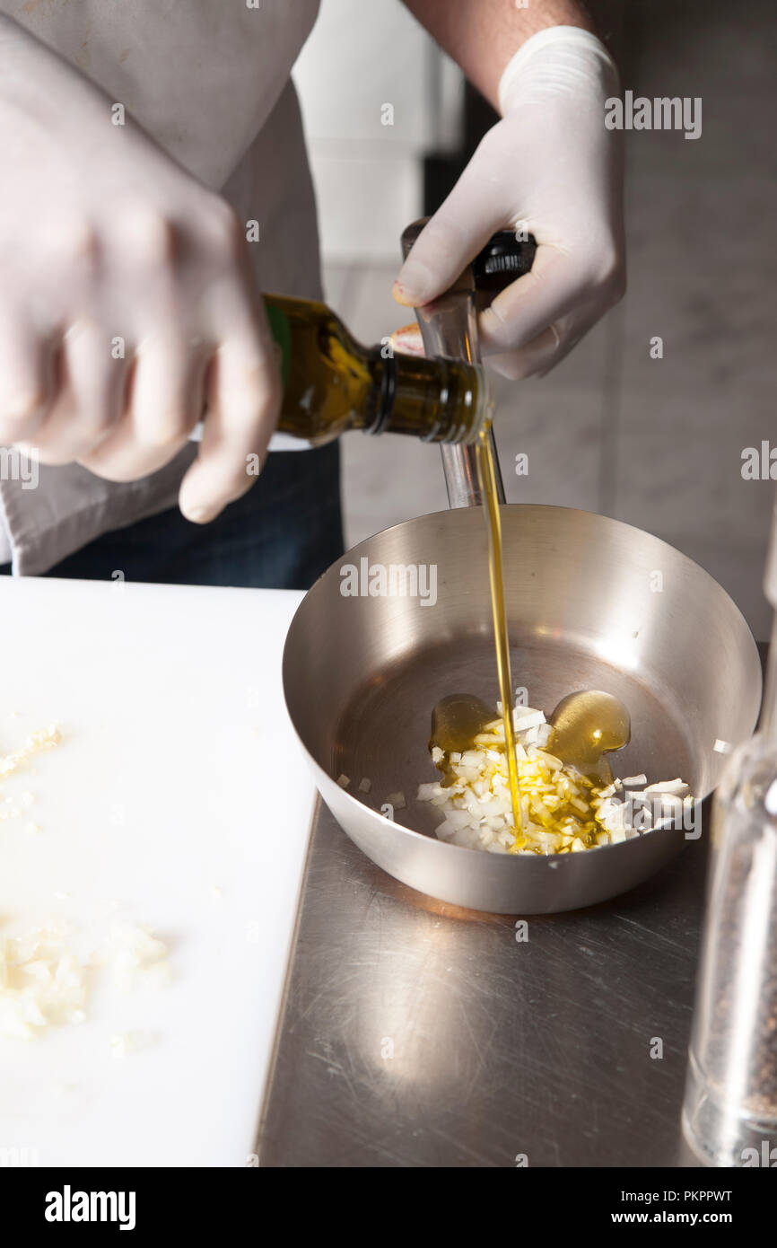 Cook pours oil hi-res stock photography and images - Alamy