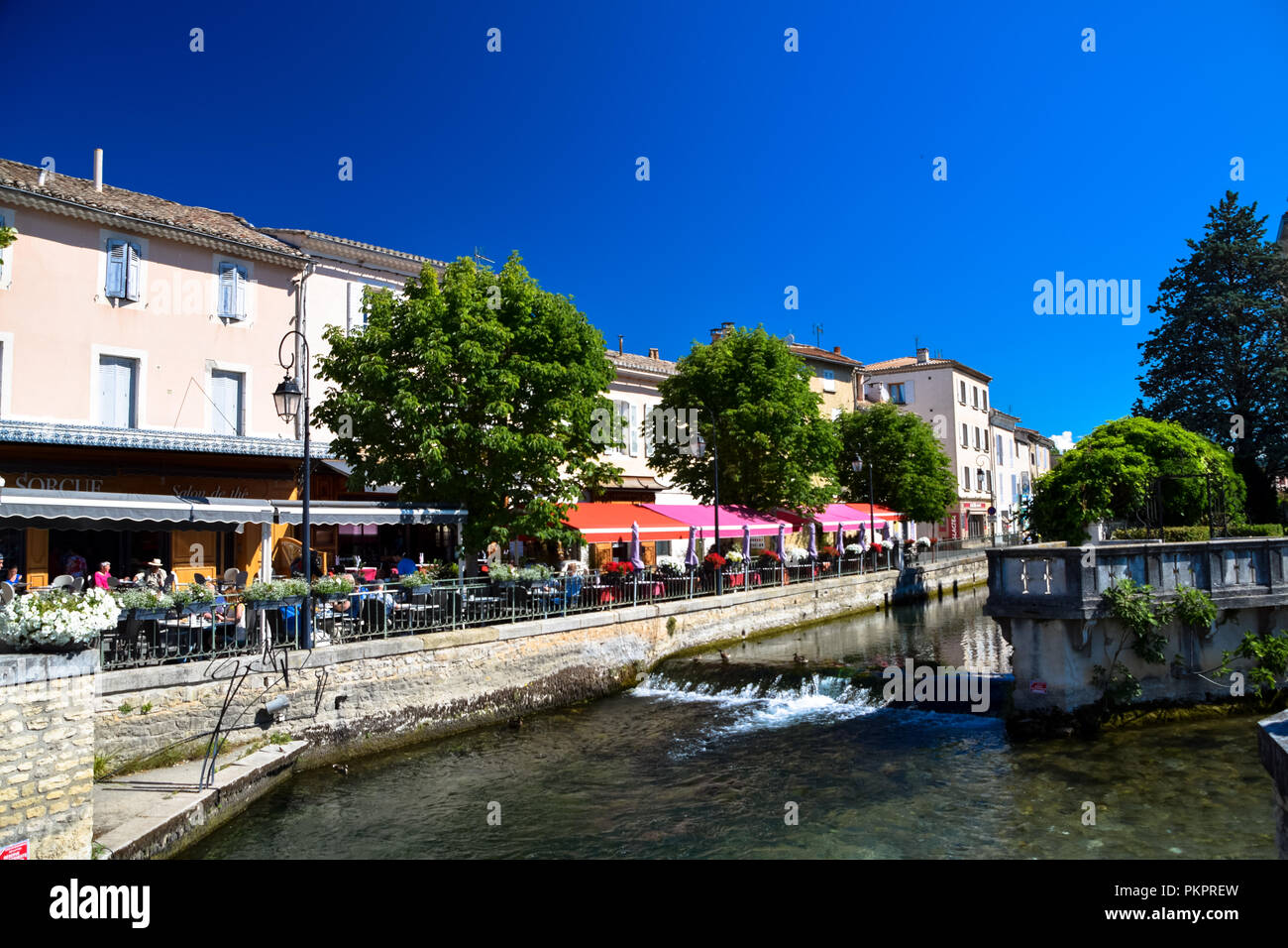 The lovely village of Isle Sur la Sorgue straddling the Sorgue RIver in ...