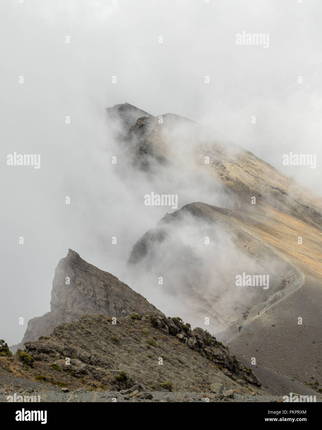 The summit of Mount Meru partly covered by clouds, Arusha, Tanzania ...