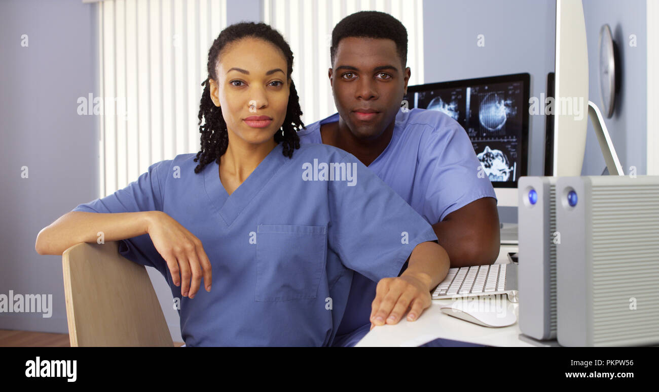 Two Black nurses in nurses station sitting at computer Stock Photo - Alamy