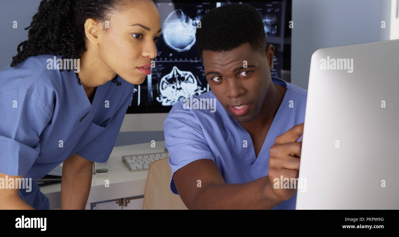 Two African American Medical specialists using computers Stock Photo ...