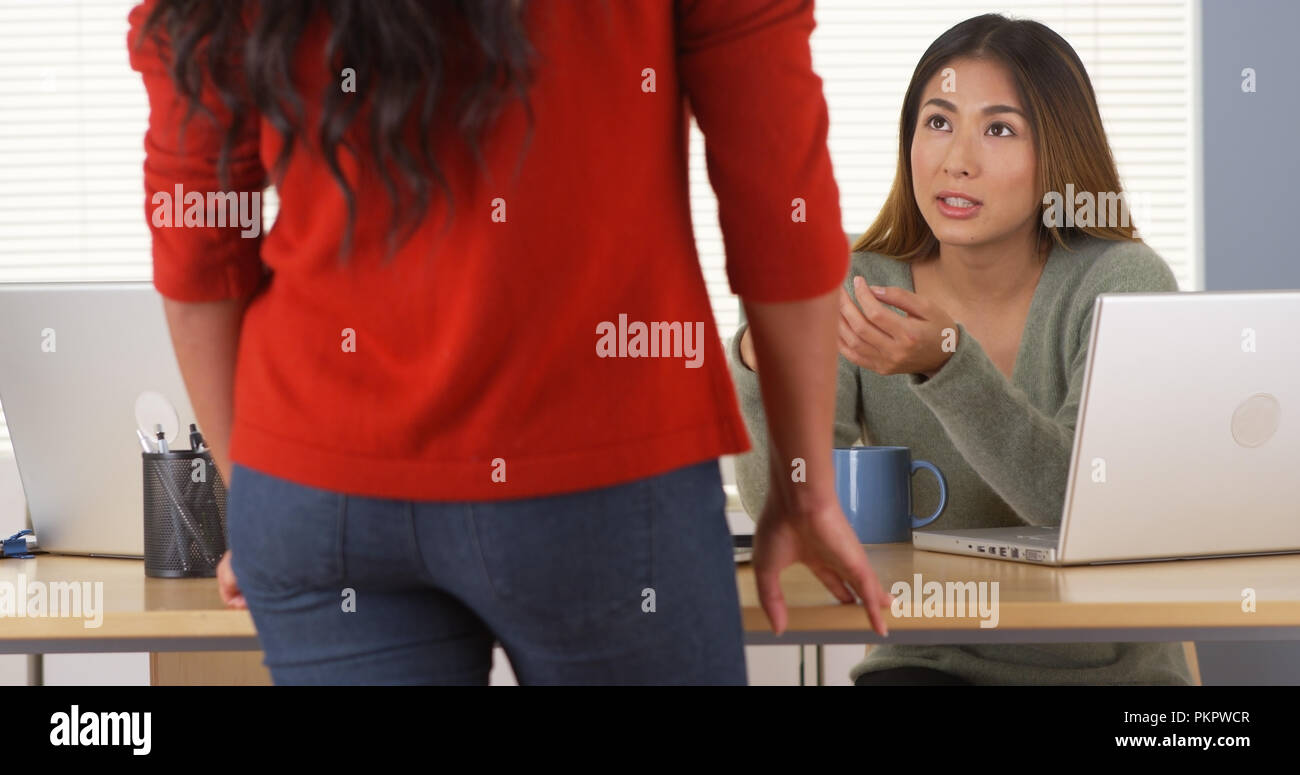 Japanese manager assigning task to employee Stock Photo - Alamy