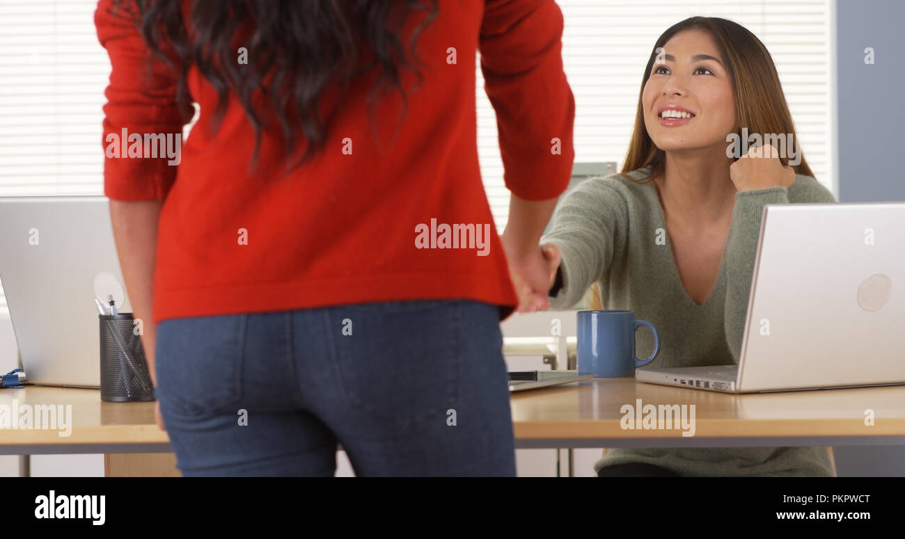 Japanese manager happy with employee Stock Photo - Alamy