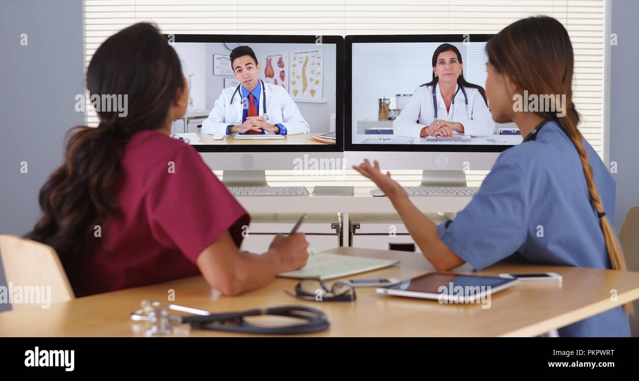 Group of diverse medical doctors video conferencing Stock Photo - Alamy