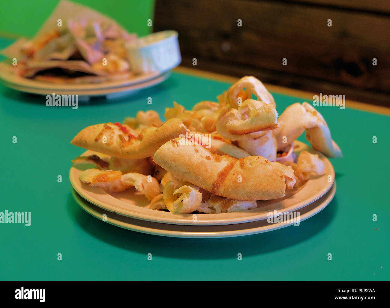 Leftover crust at a pizza buffet restaurant Stock Photo - Alamy