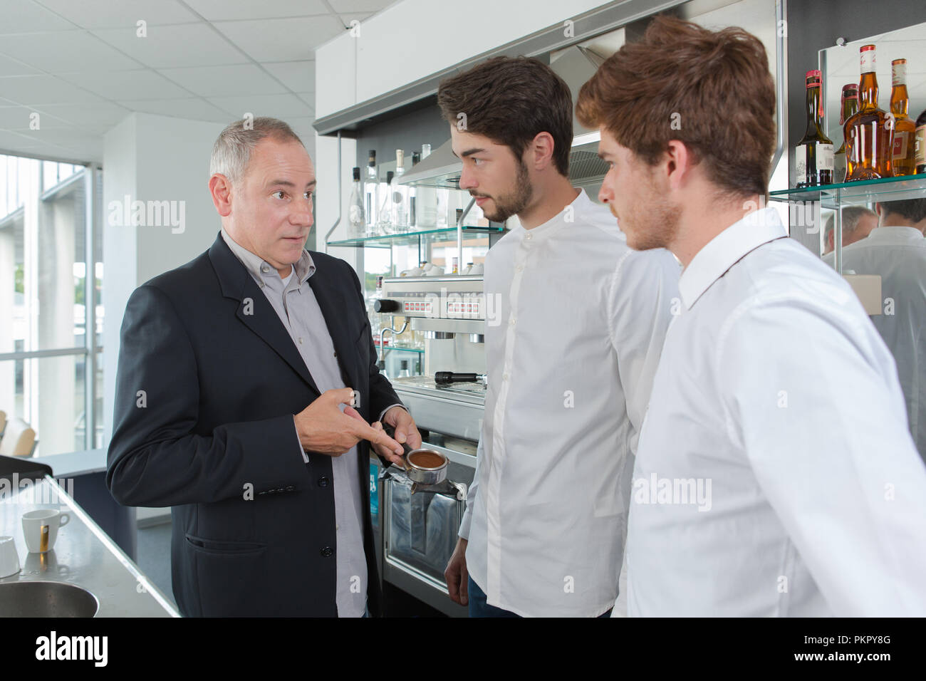 manager of a coffee shop with staff memebers Stock Photo - Alamy